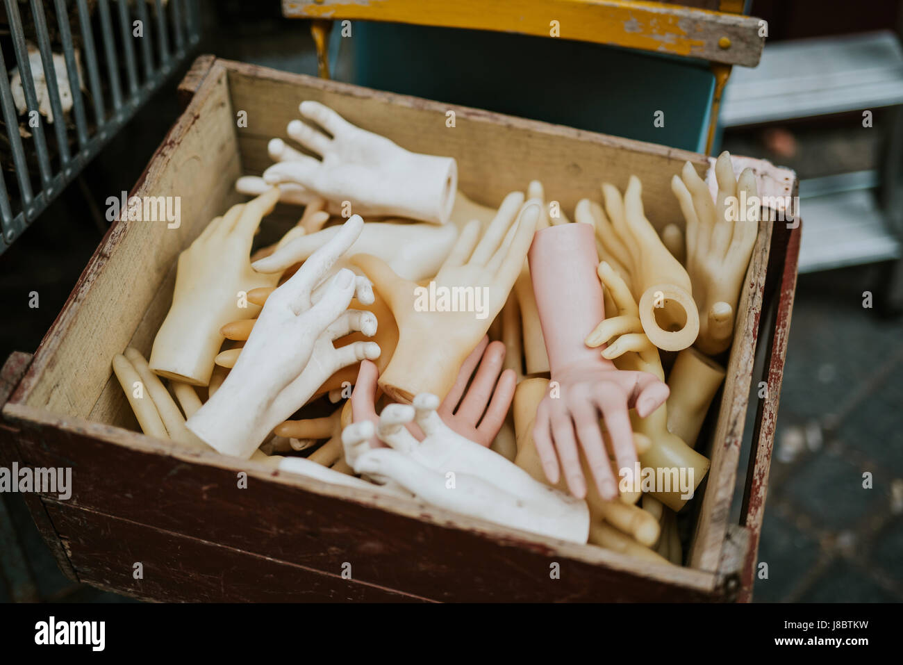 Group of plastic hands in wooden box Stock Photo - Alamy