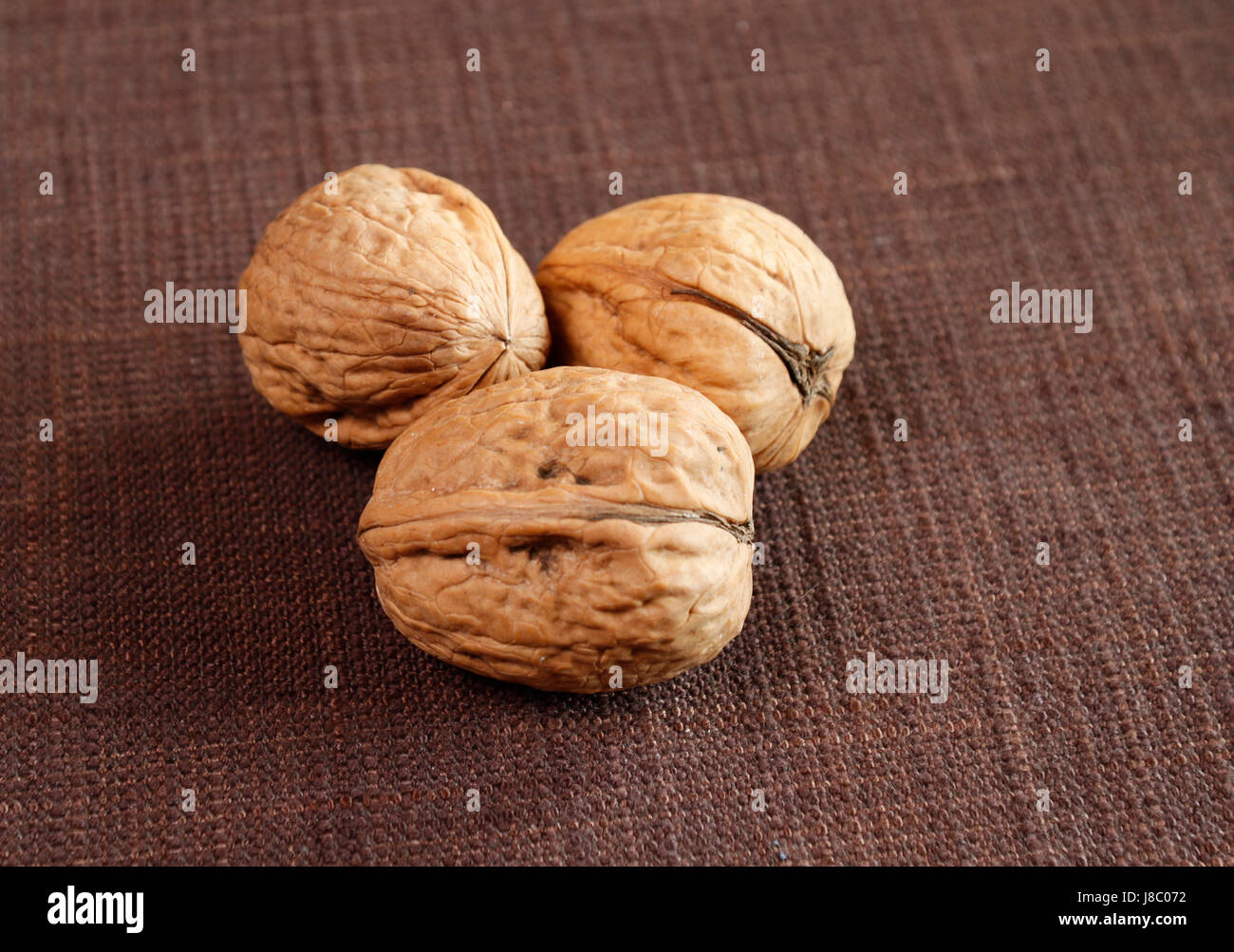 three walnuts with copyspace Stock Photo - Alamy