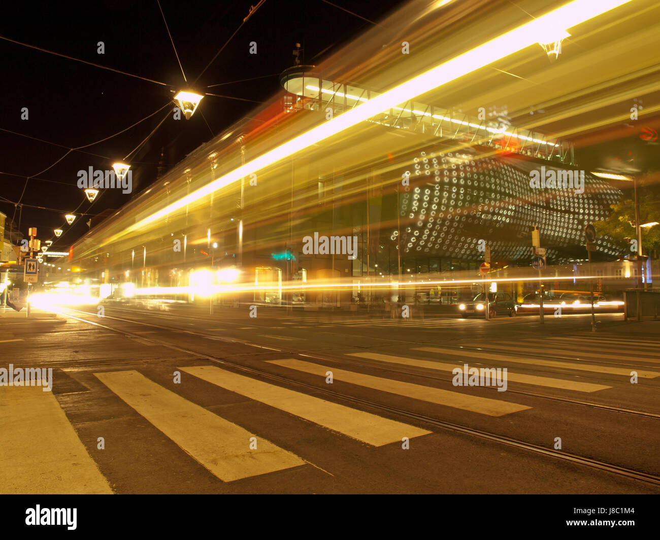 night photograph, lights, tracks, tram, zebra crossing, street, road ...