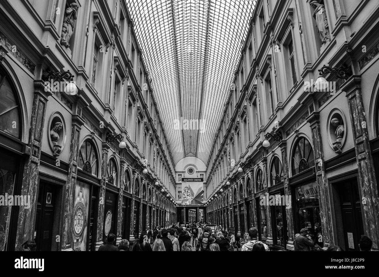 a crowded old fancy shopping street in europe is captured in blach and ...