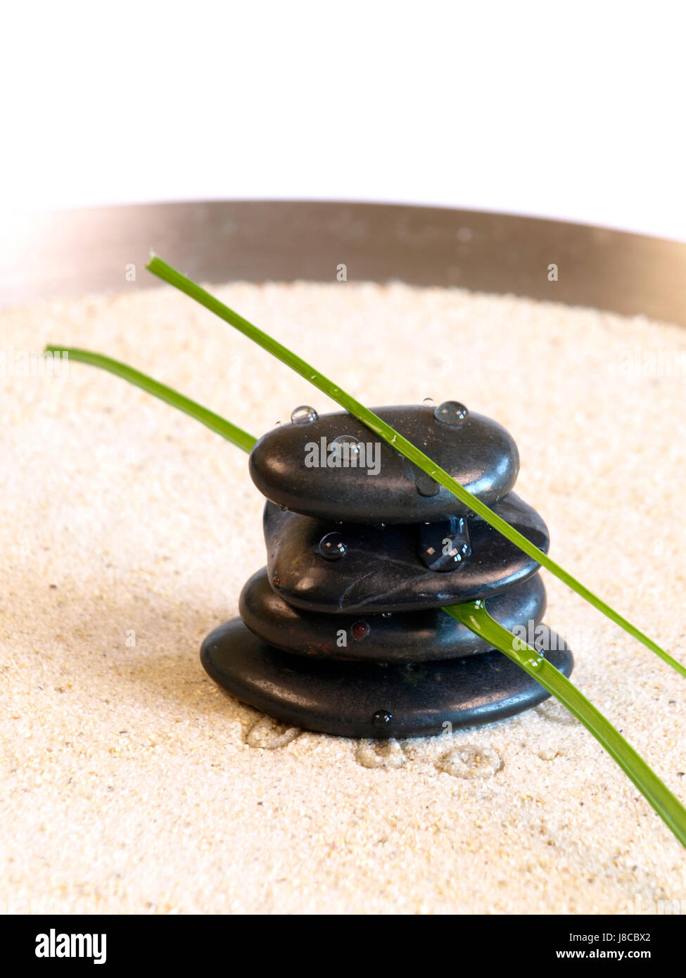 stacked hot stones on sand Stock Photo - Alamy