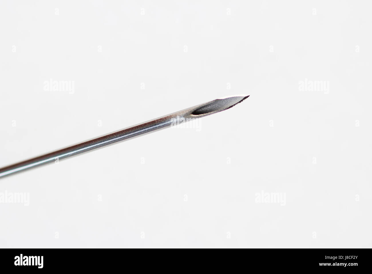 Macro shot of a medical needle from a syringe on a white background ...