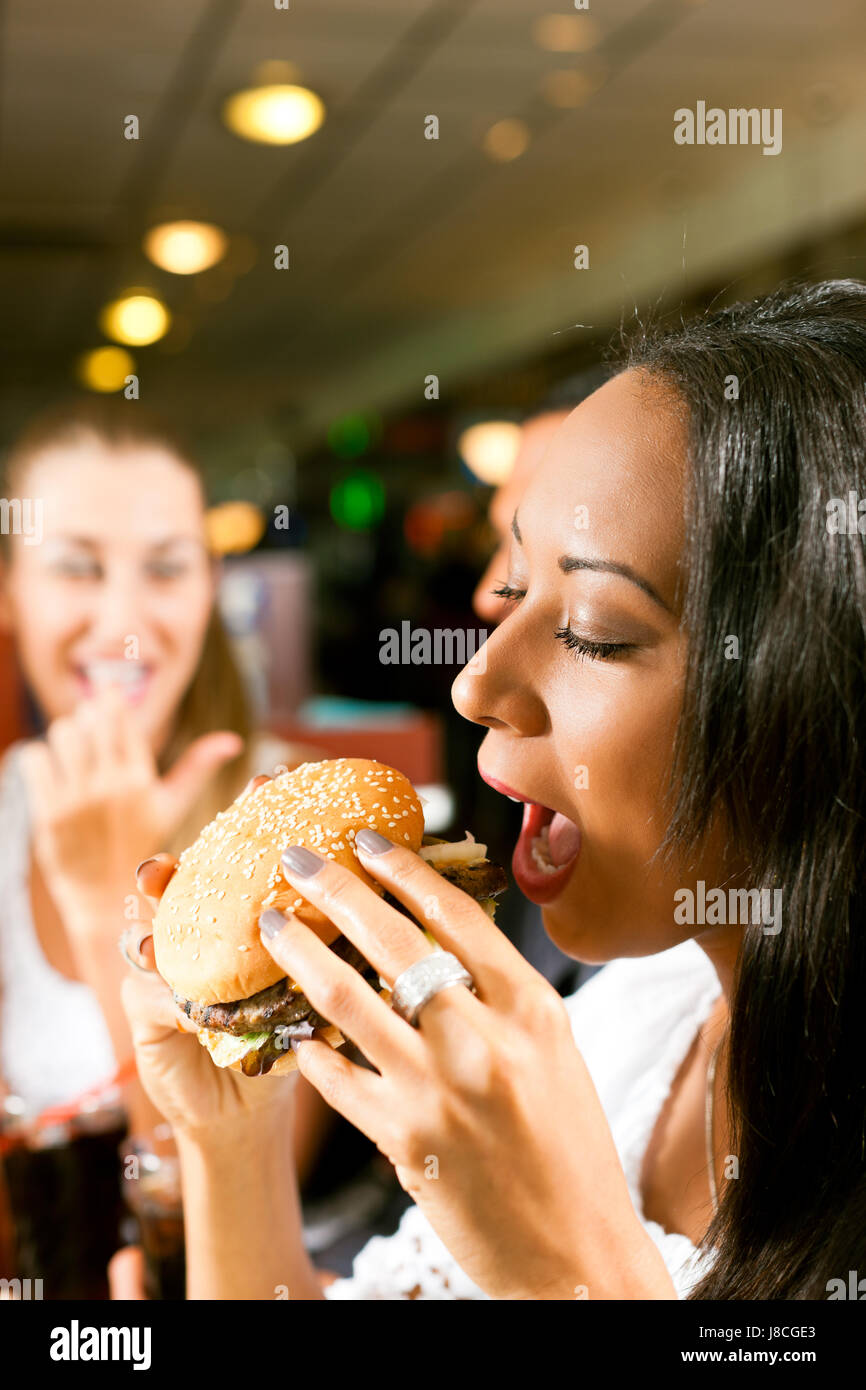 friends eating fast food in a restaurant Stock Photo - Alamy