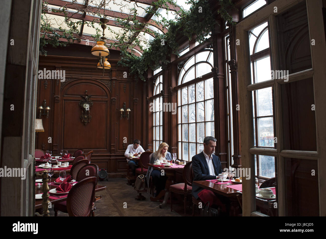 Moscow: people sitting in the veranda of Cafe Pushkin, a famous ...