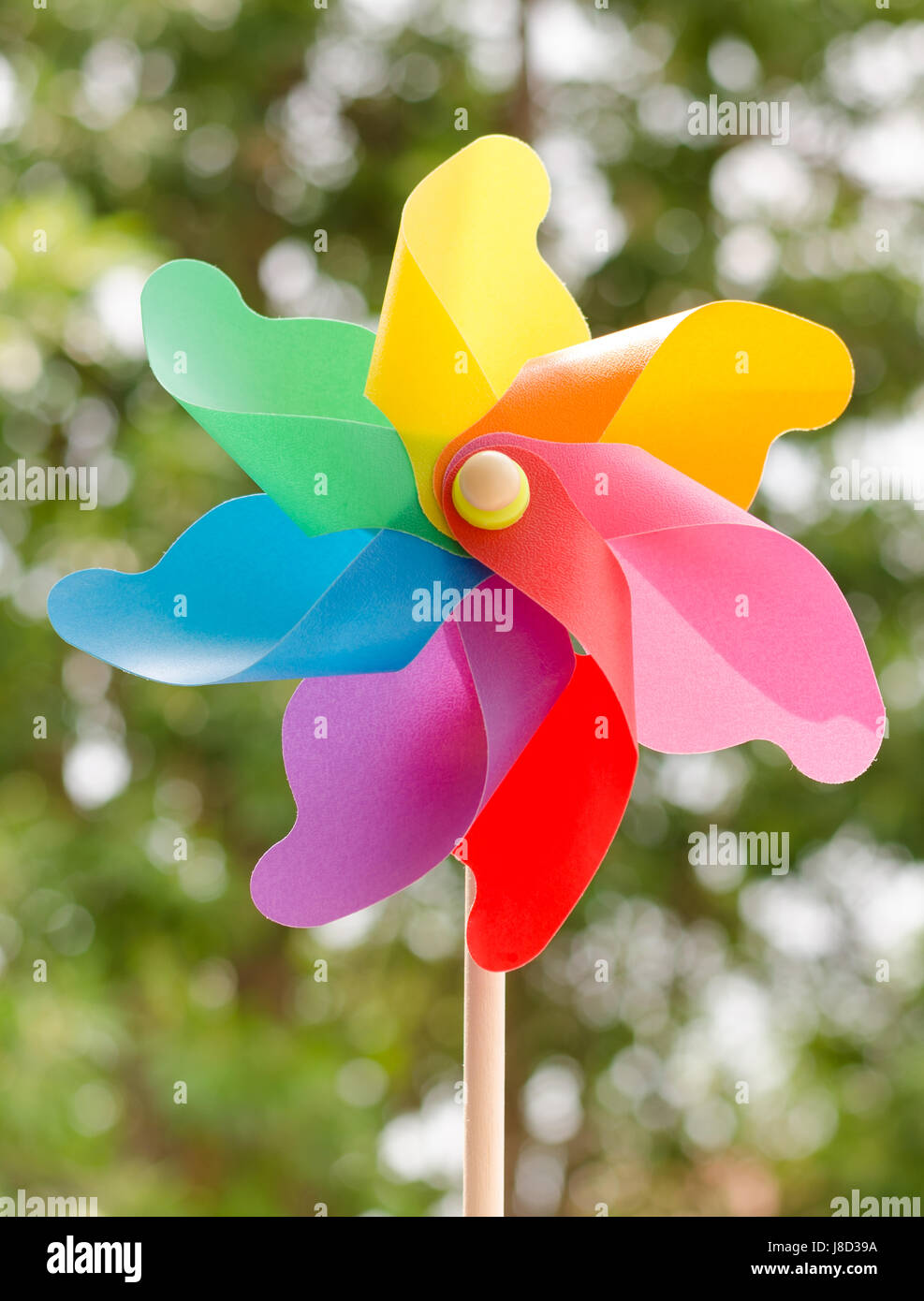 A Colorful Pinwheel with green tree background Stock Photo - Alamy