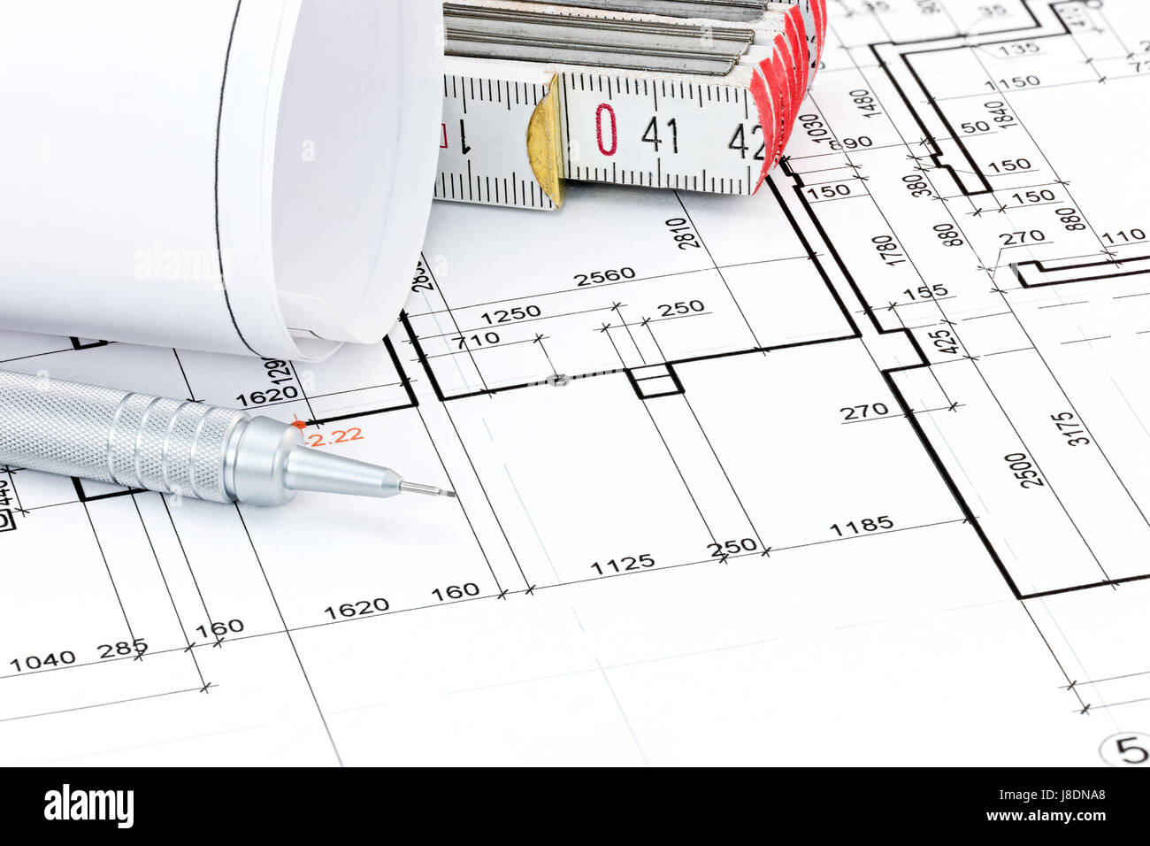 pencil and wooden folding ruler on architectural blueprint floor plan ...