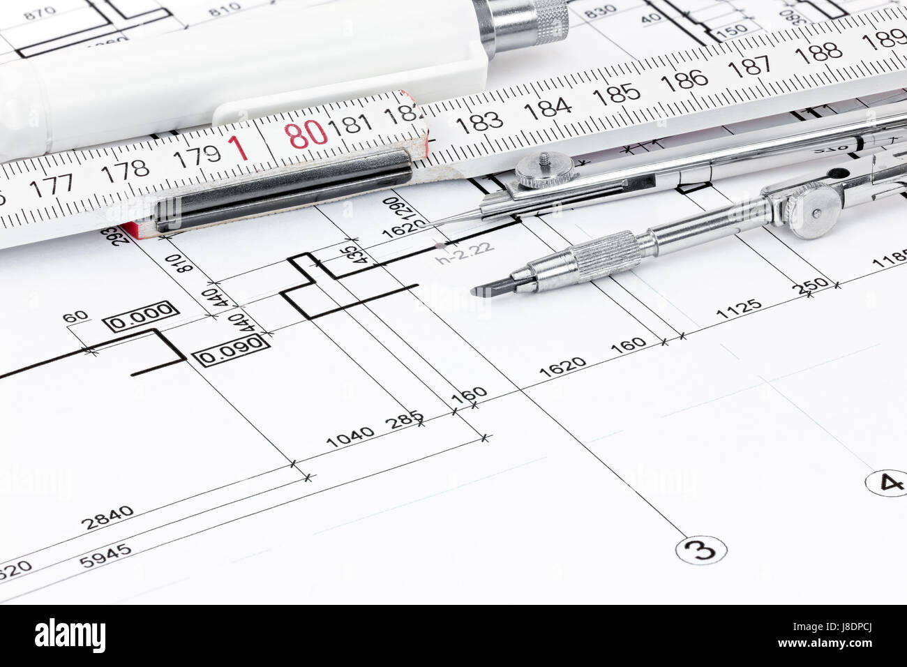 drawing compass, folding rule, pen on architectural drawing background ...
