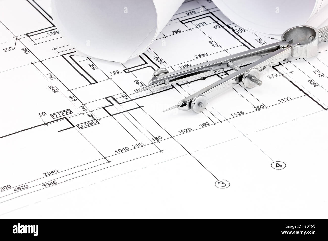 architectural blueprint floor plans with rolls and drawing compass ...