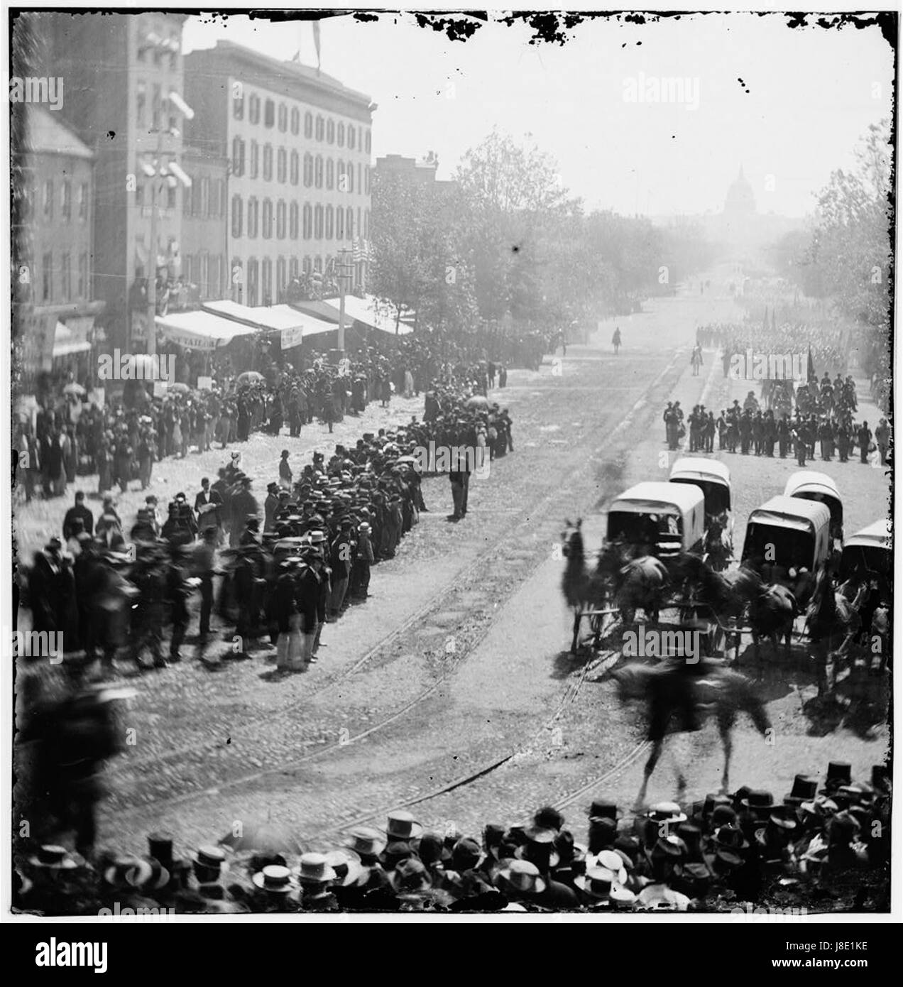 This scene depicts a group of ambulances, accompanied by a marching ...