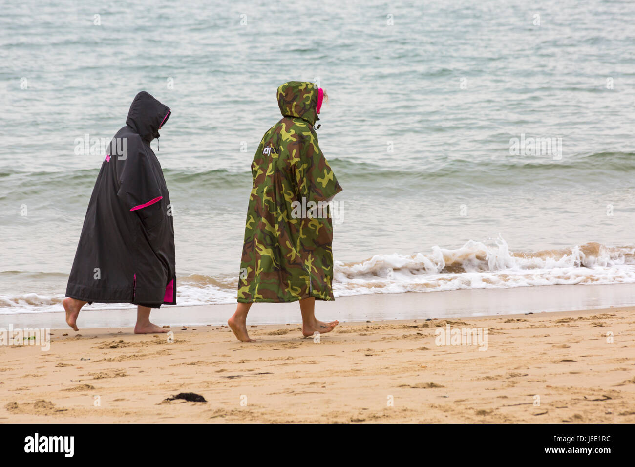 Two swimmers wearing dryrobes hi-res stock photography and images - Alamy