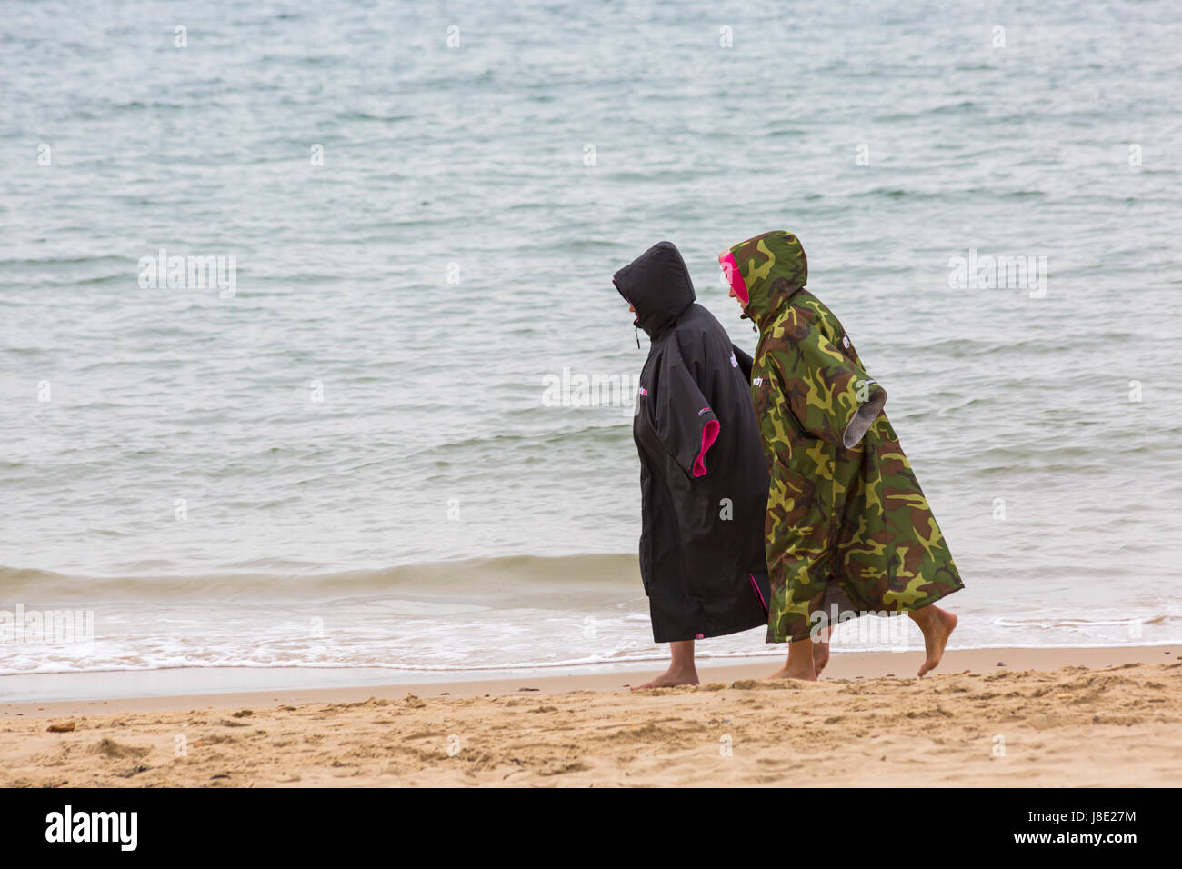 Two swimmers wearing dryrobes hi-res stock photography and images - Alamy