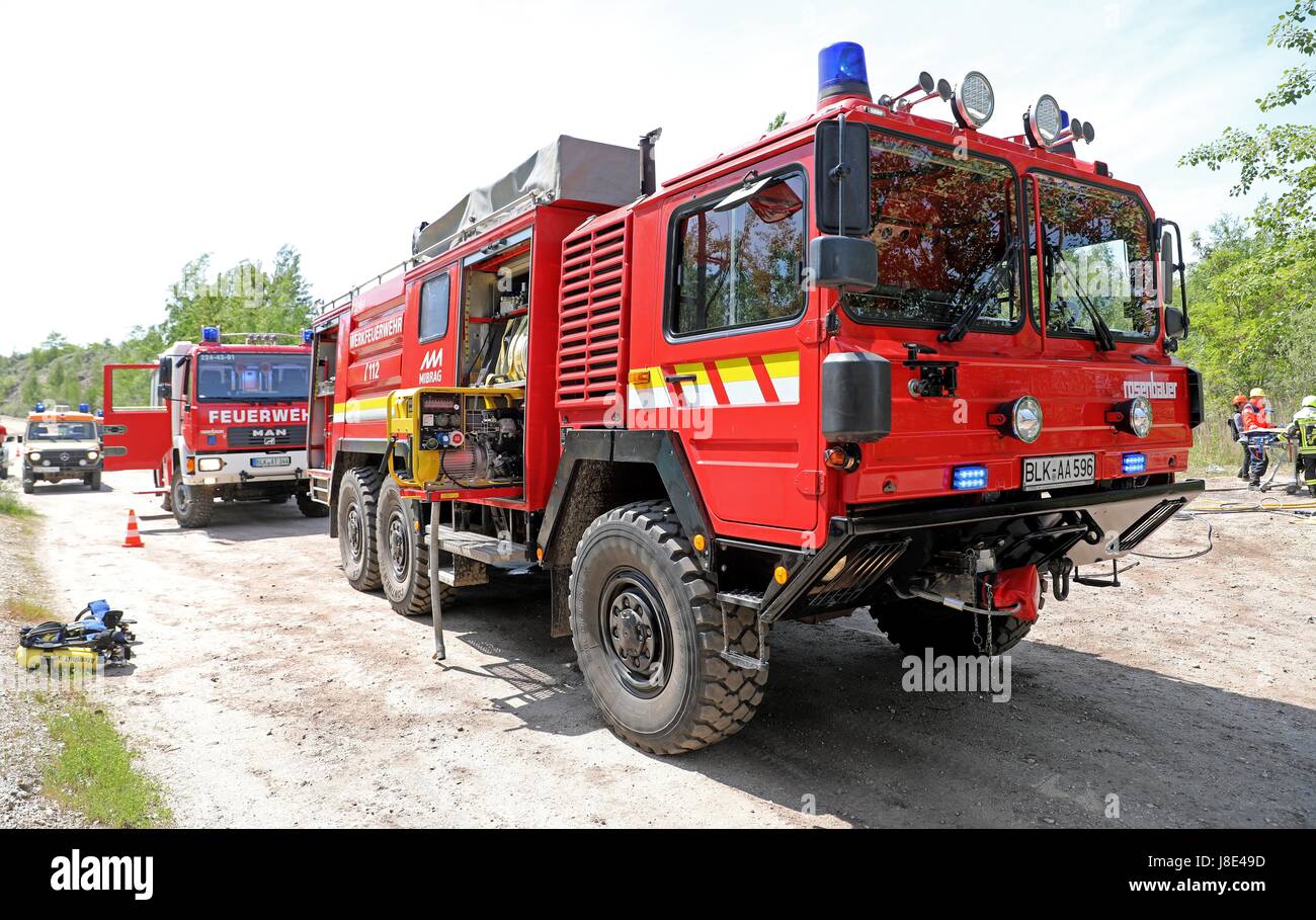 Emergency vehicles of the Mibrag works fire brigade park during a ...