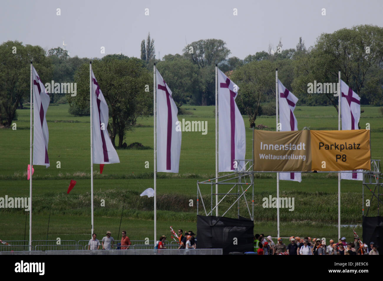Flags of the Evangelical Church in Germany file at the entrance. Around ...