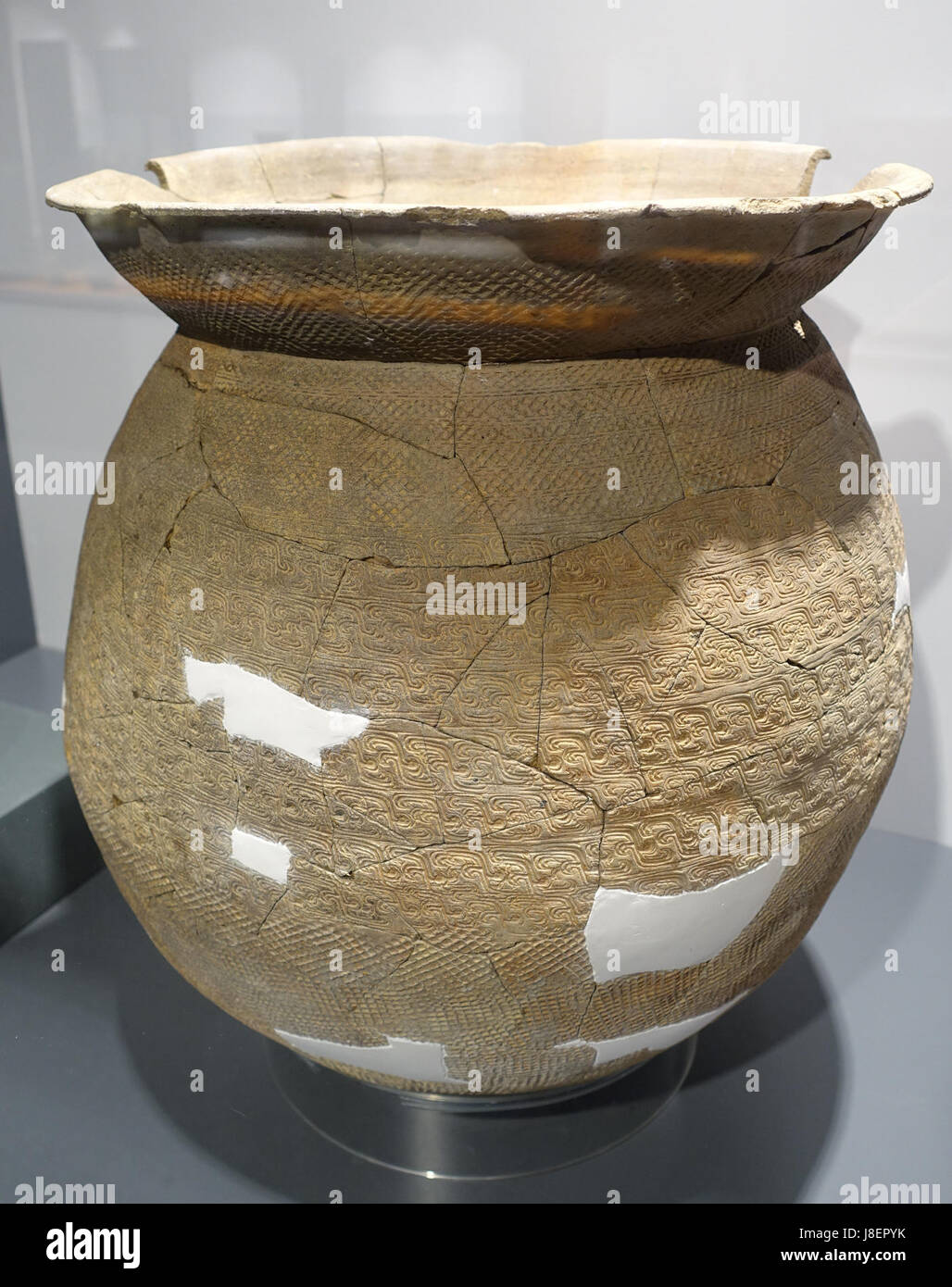 This hard pottery urn, dating to the Bronze period, features a ...