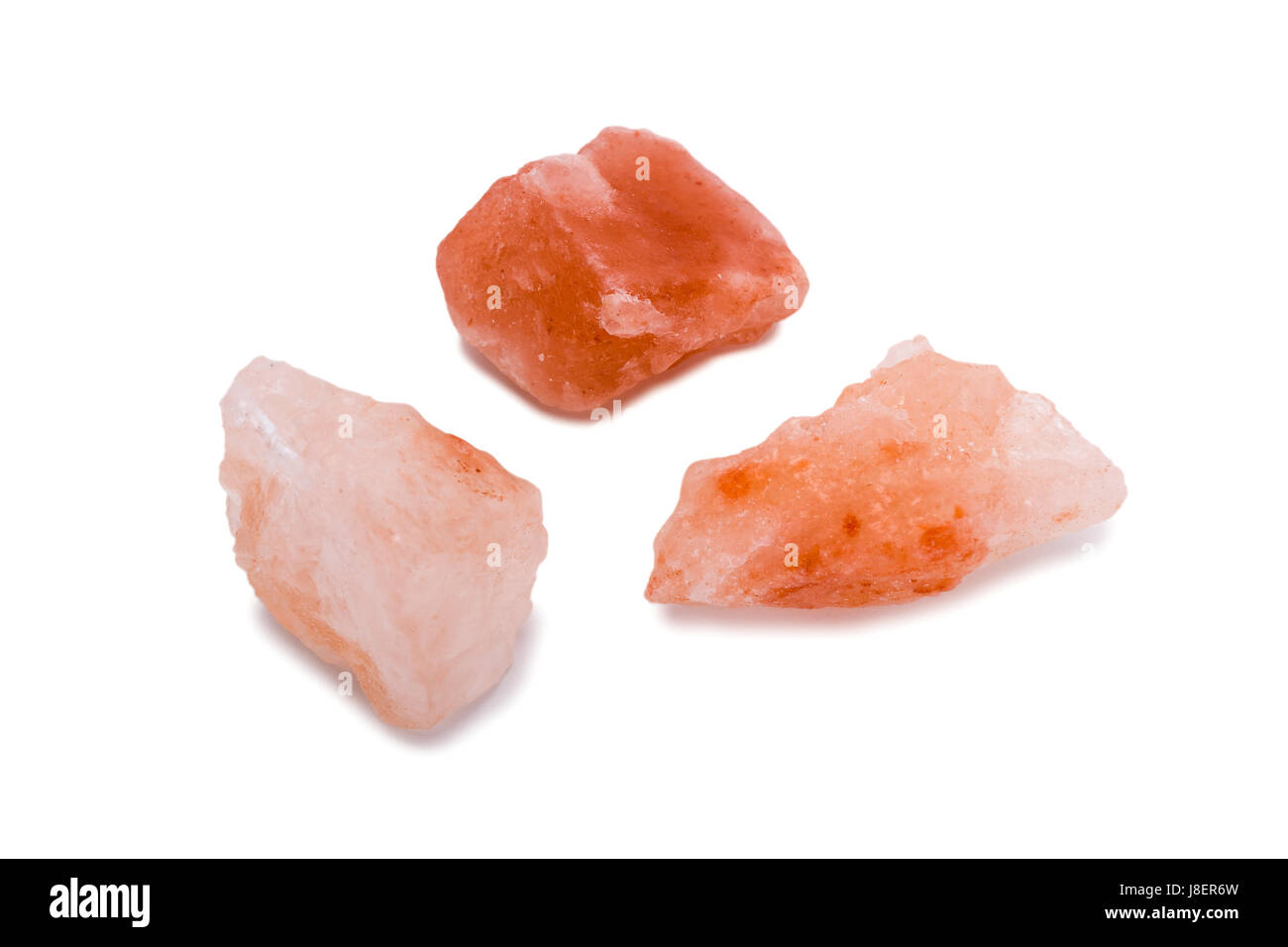 Closeup of Himalayan pink rock salt Isolated over white background ...