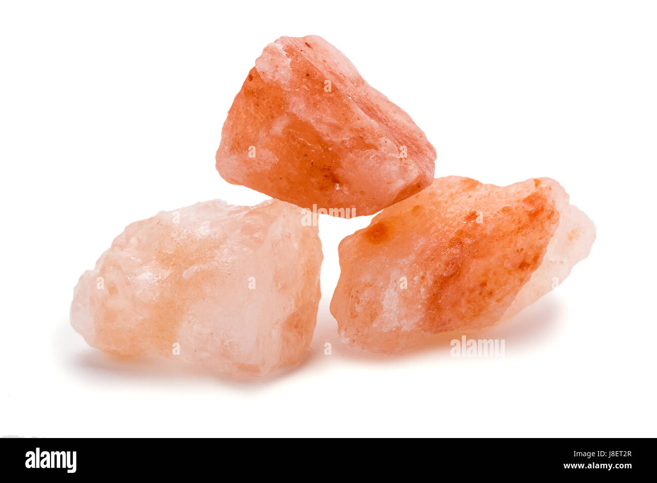 Closeup of Himalayan pink rock salt Isolated over white background ...