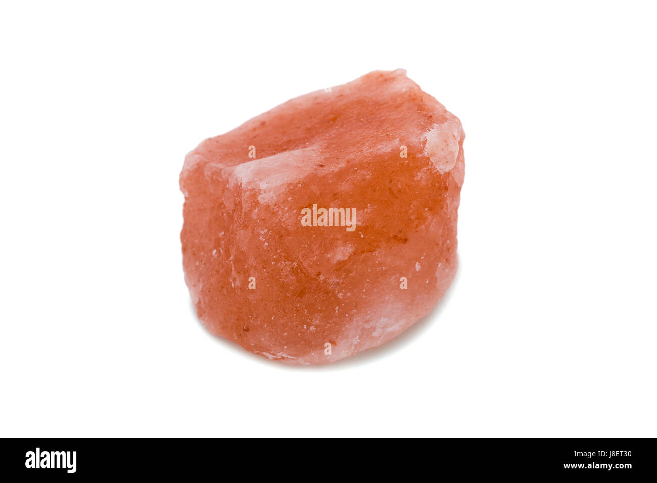 Closeup of Himalayan pink rock salt Isolated over white background ...