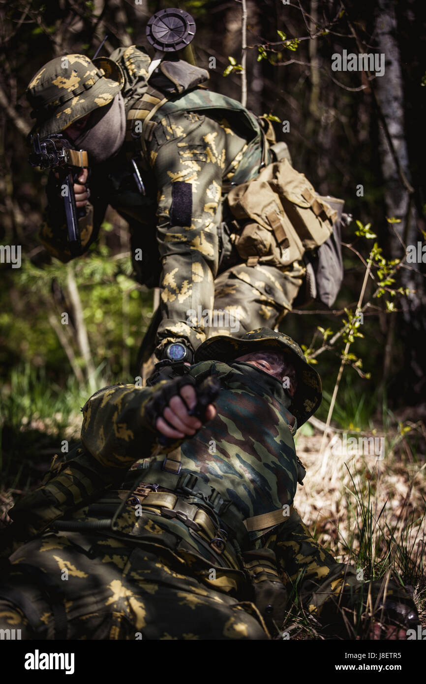 The soldier saves his comrade in battle Stock Photo - Alamy