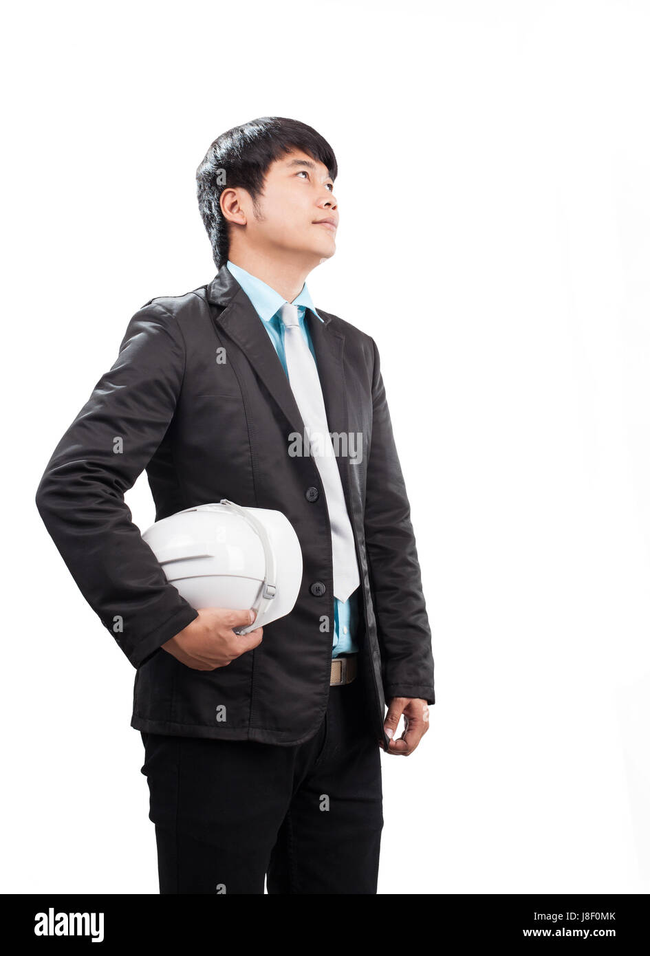 portrait of engineering man standing and holding safety helmet looking ...