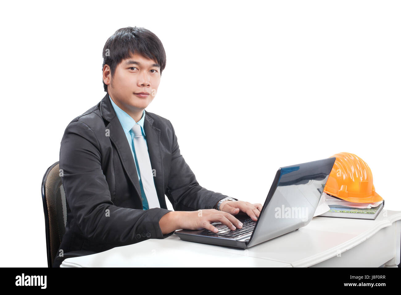 portrait young engineering man sittin and working on laptop computer ...
