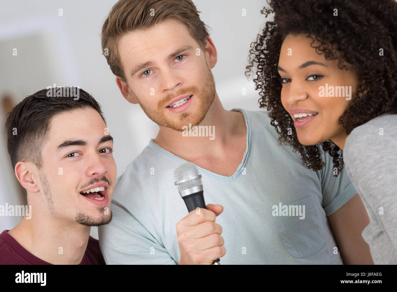 the trio singing a song Stock Photo - Alamy