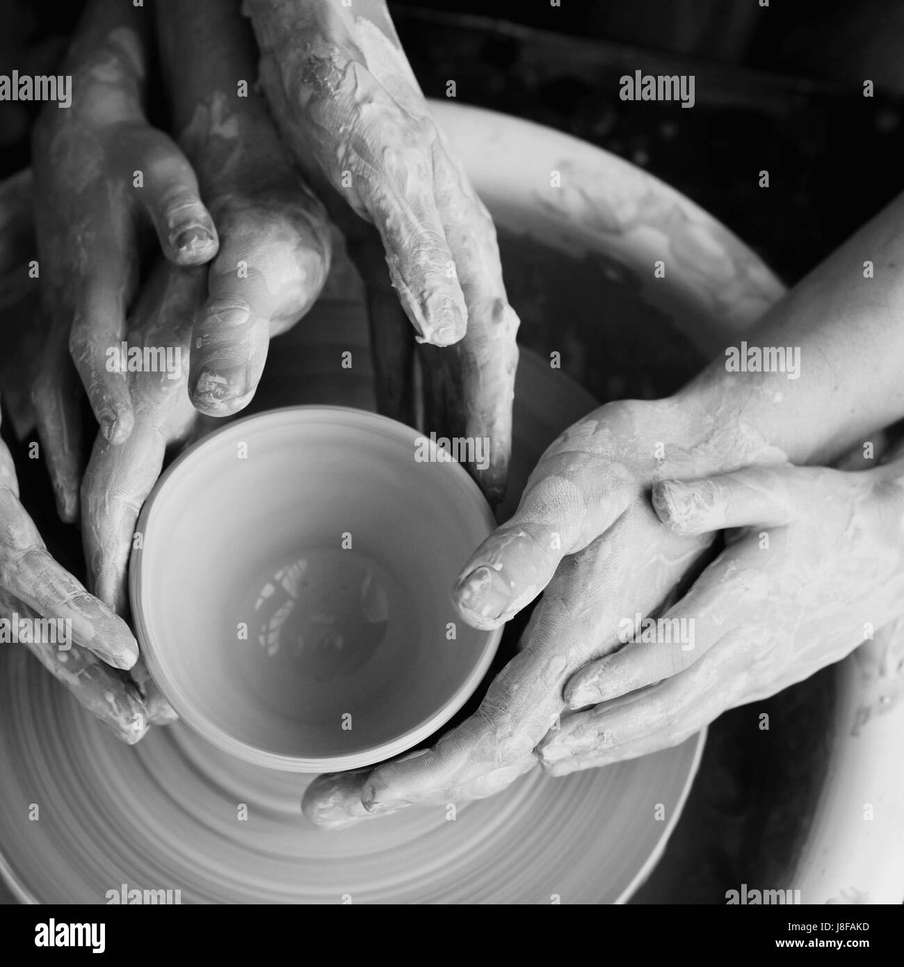 Family working on pottery wheel. Top view of mother, father and son ...