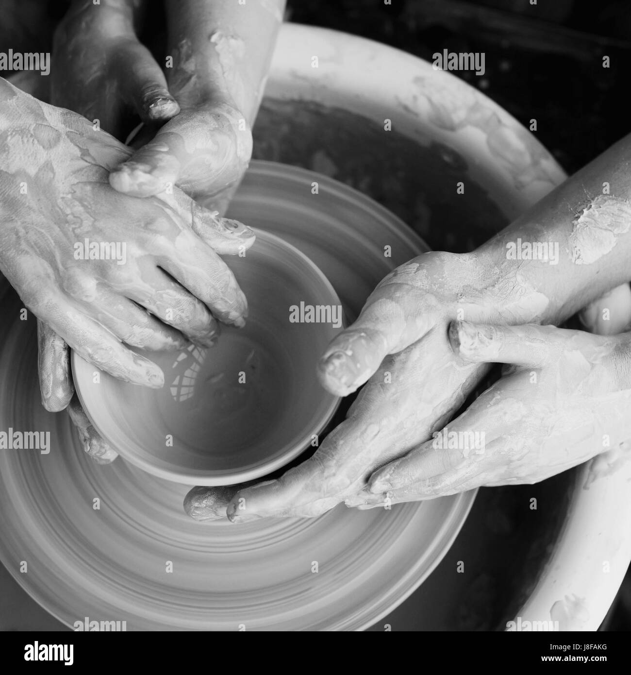 Family working on pottery wheel. Top view of mother, father and son ...