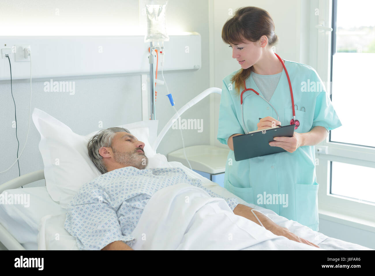 Patient observing nurse hi-res stock photography and images - Alamy