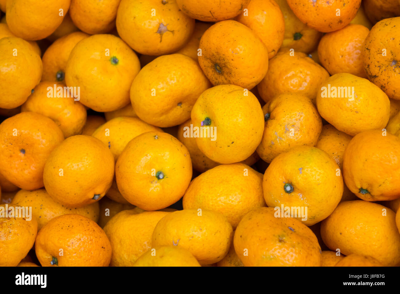 Many small orange fruit delicacies in Southeast Asia Stock Photo - Alamy