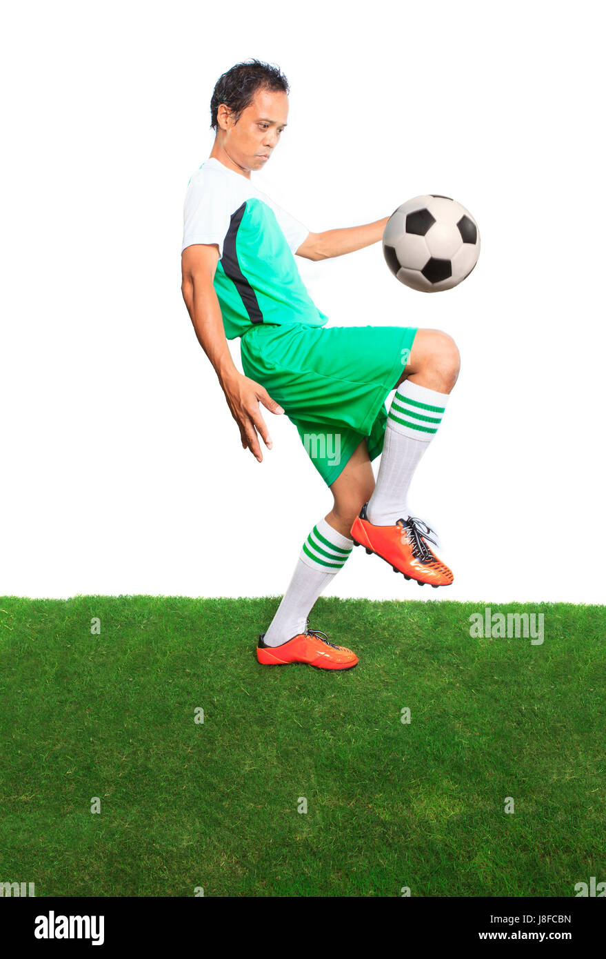 portrait of football ,soccer players playing soccer ball on green grass ...