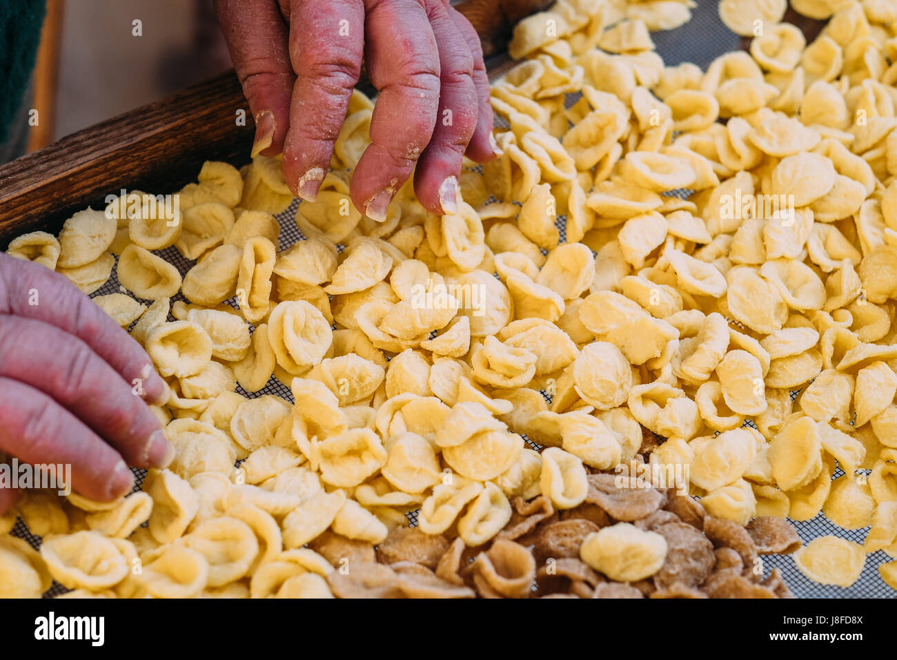 An elderly woman making Orecchiette pasta in Bari Vecchia, Puglia ...