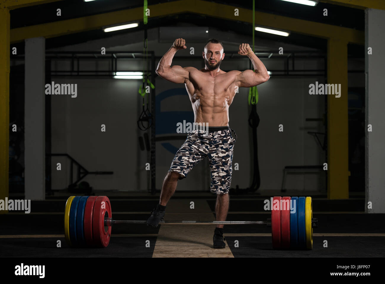 Bodybuilder Doing Heavy Weight Exercise For Back With Barbell In Modern ...