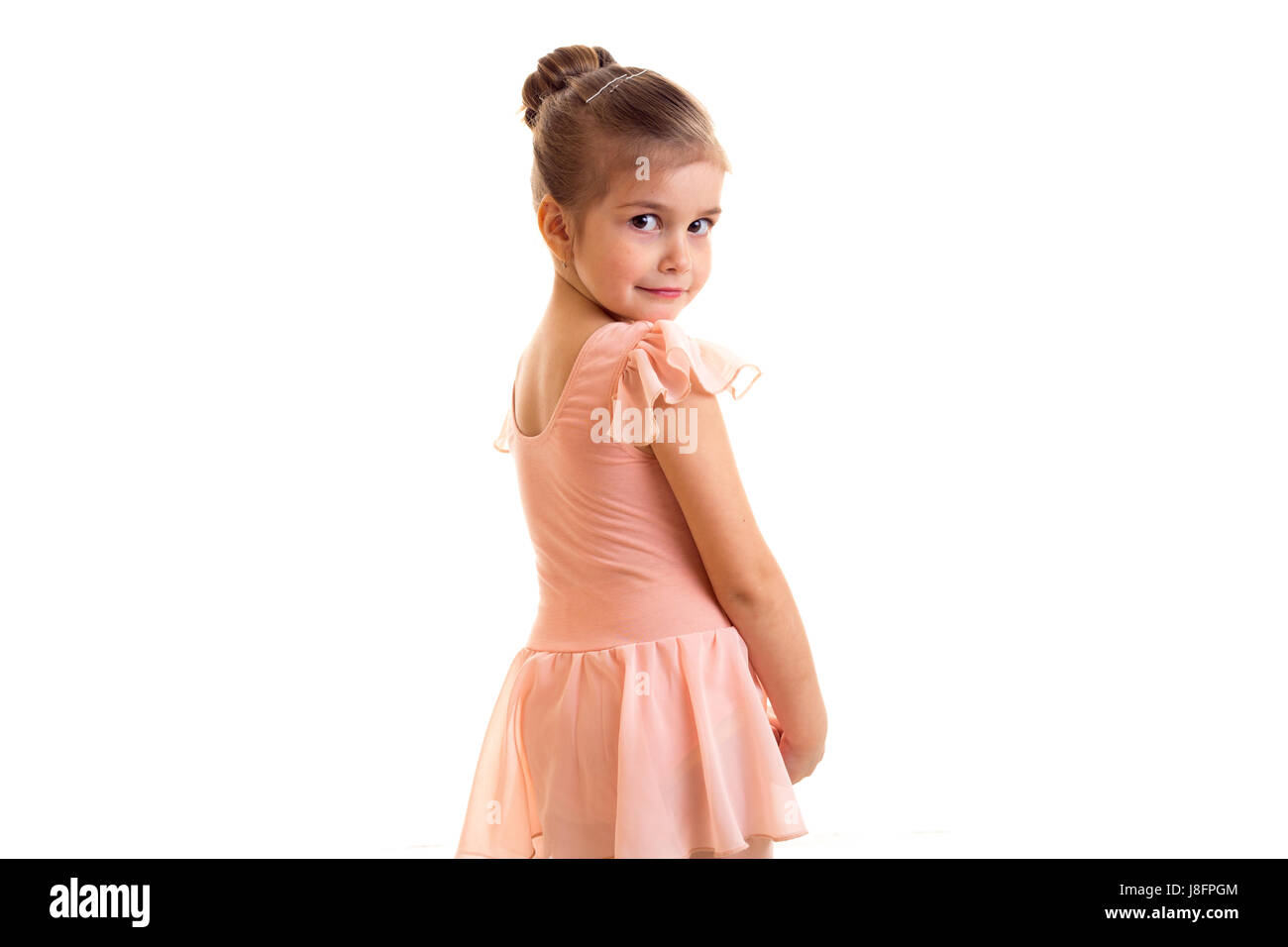 Sad little girl in pink dress with bundle dancing on white background ...