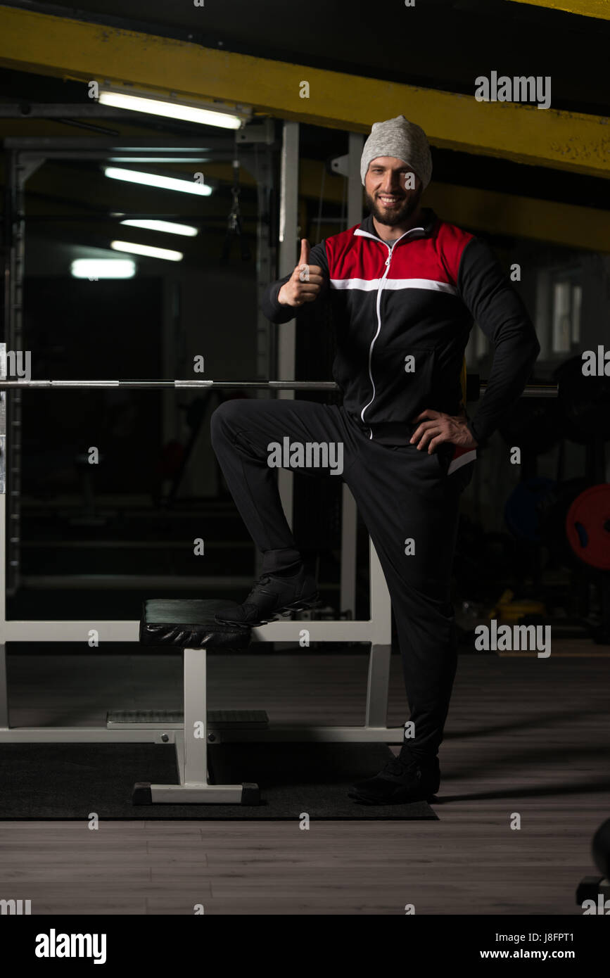 Portrait Of A Physically Fit Man In Track Suit Resting His Well Trained ...