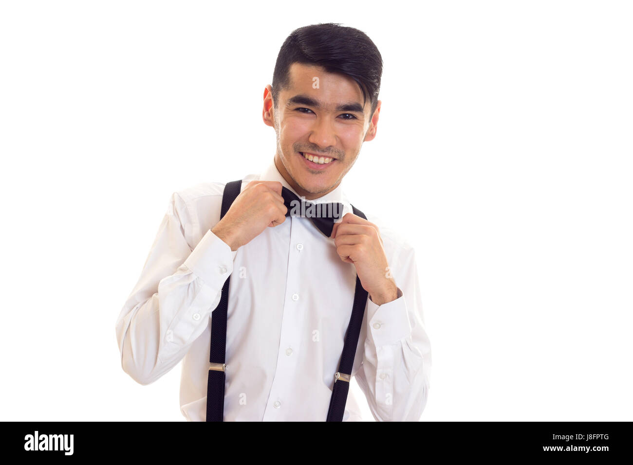 Young smart-looking man in white shirt with black bow-tie and black ...