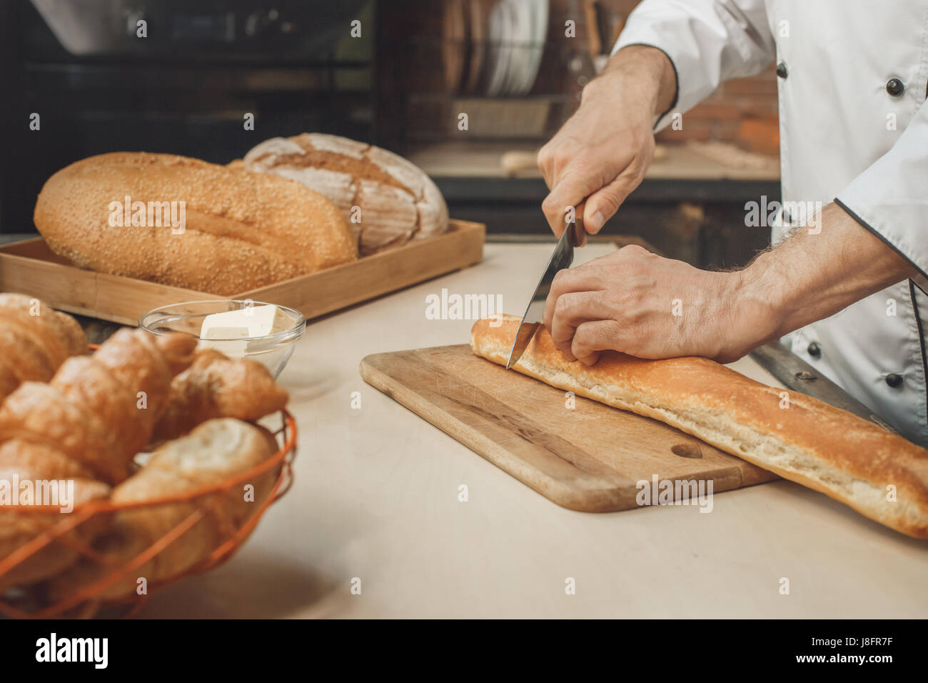 Bakery chef cooking bake in the kitchen professional Stock Photo - Alamy