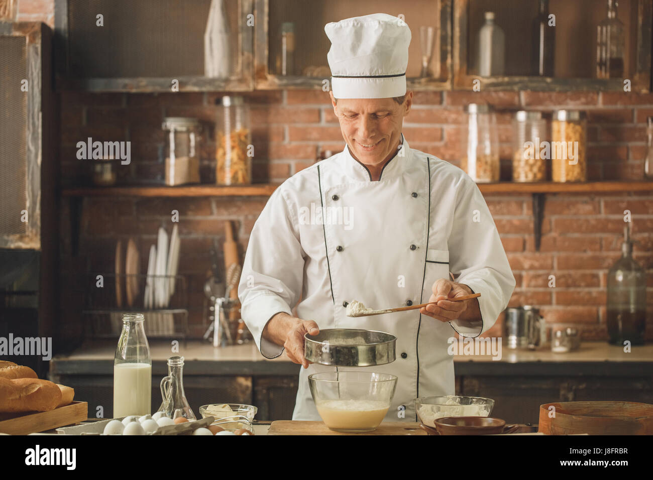 Bakery chef cooking bake in the kitchen professional Stock Photo - Alamy