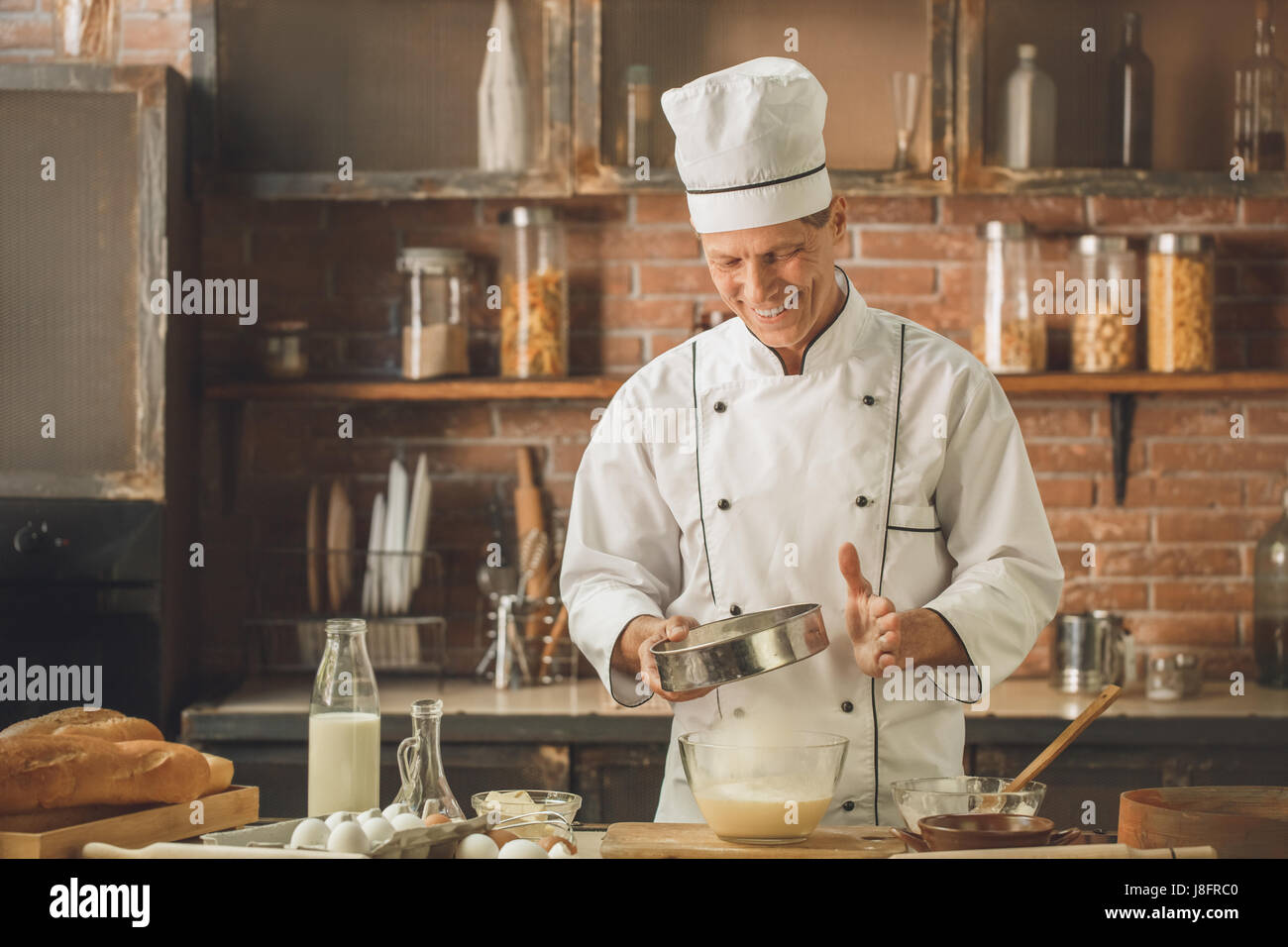 Bakery chef cooking bake in the kitchen professional Stock Photo - Alamy
