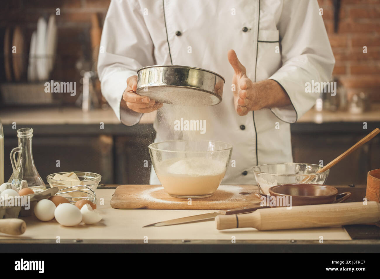Bakery chef cooking bake in the kitchen professional Stock Photo - Alamy