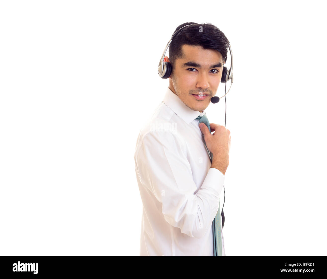Smart-looking man with dark hair in white shirt with blue tie using ...
