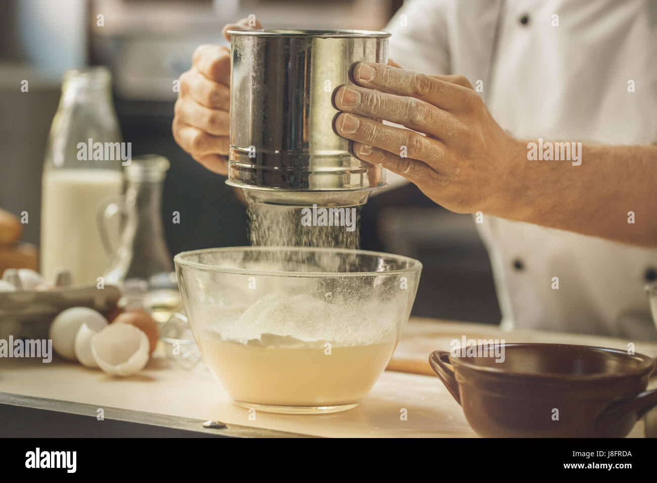 Bakery chef cooking bake in the kitchen professional Stock Photo - Alamy