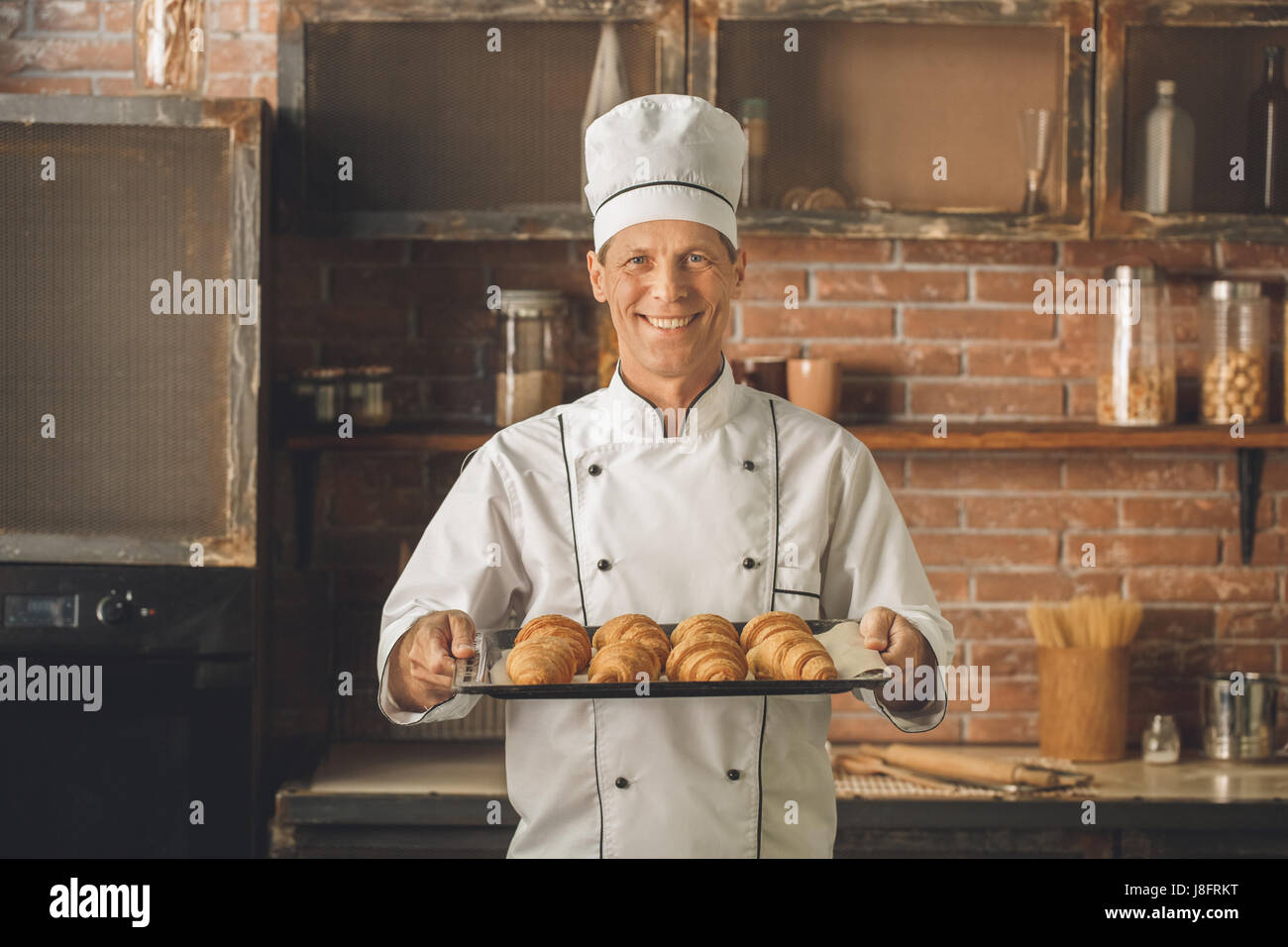 Bakery chef cooking bake in the kitchen professional Stock Photo - Alamy