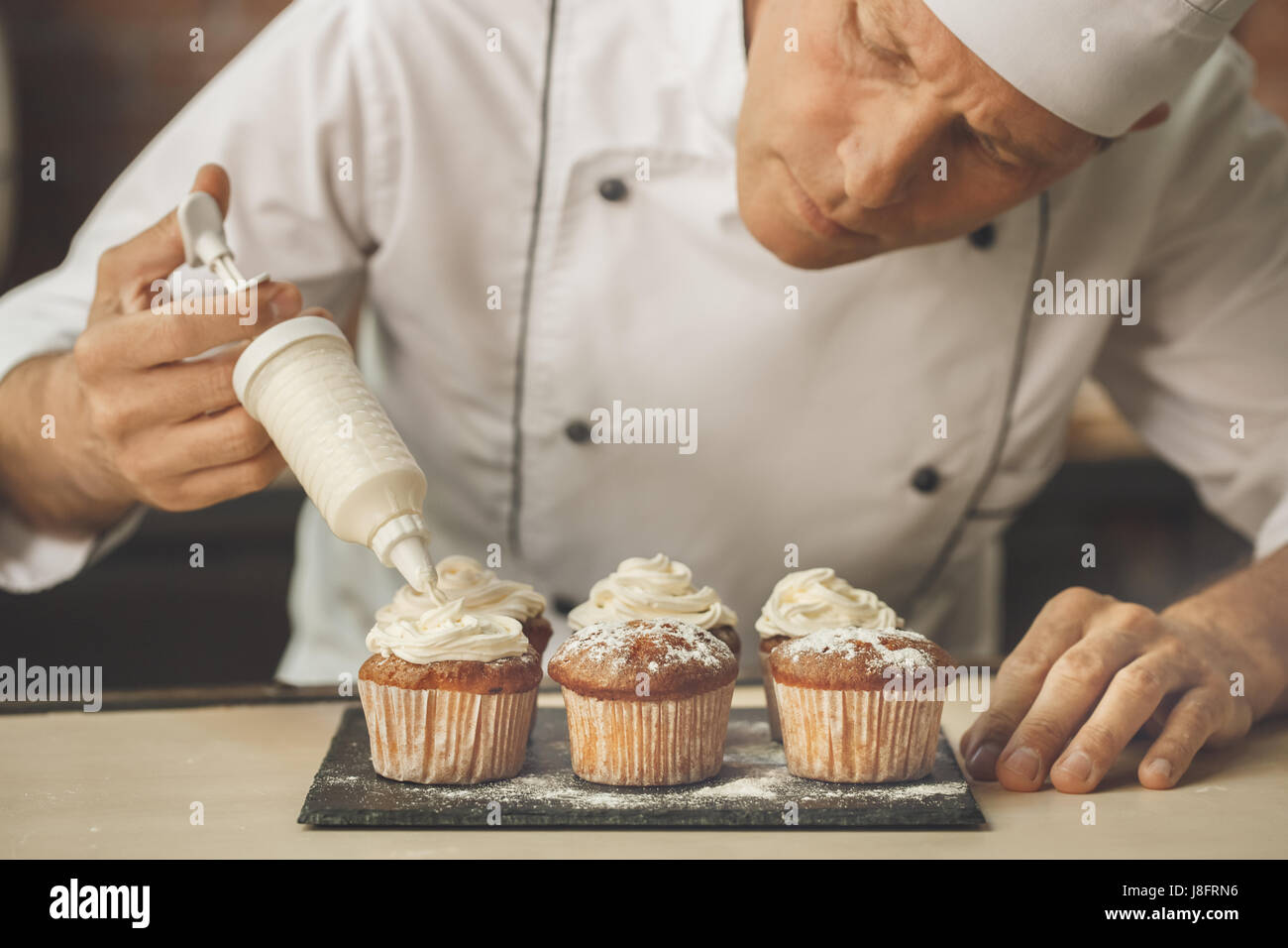 Bakery chef cooking bake in the kitchen professional Stock Photo - Alamy