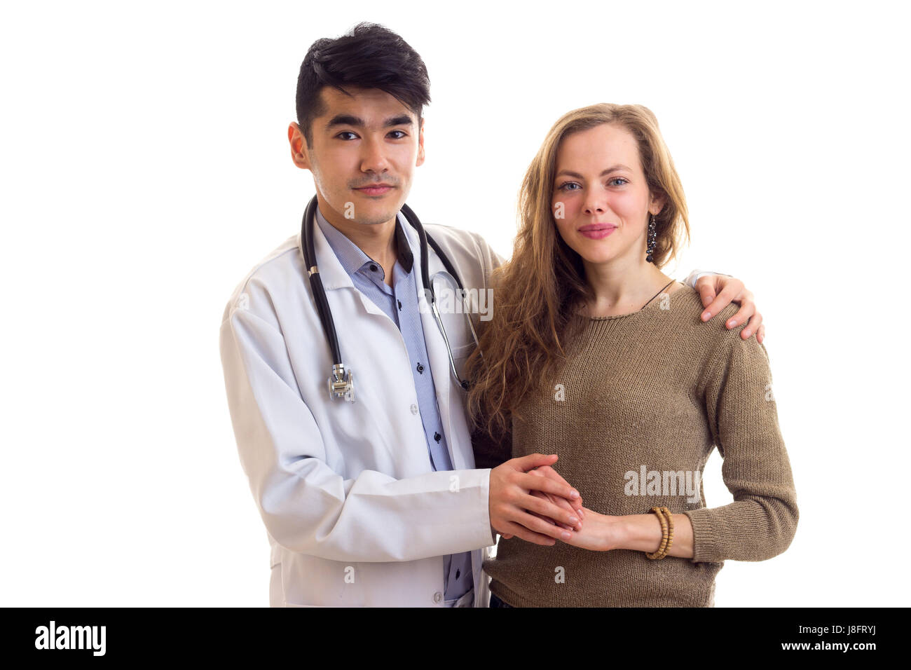 Young handsome doctor with dark hair in white gown with stethoscope on ...