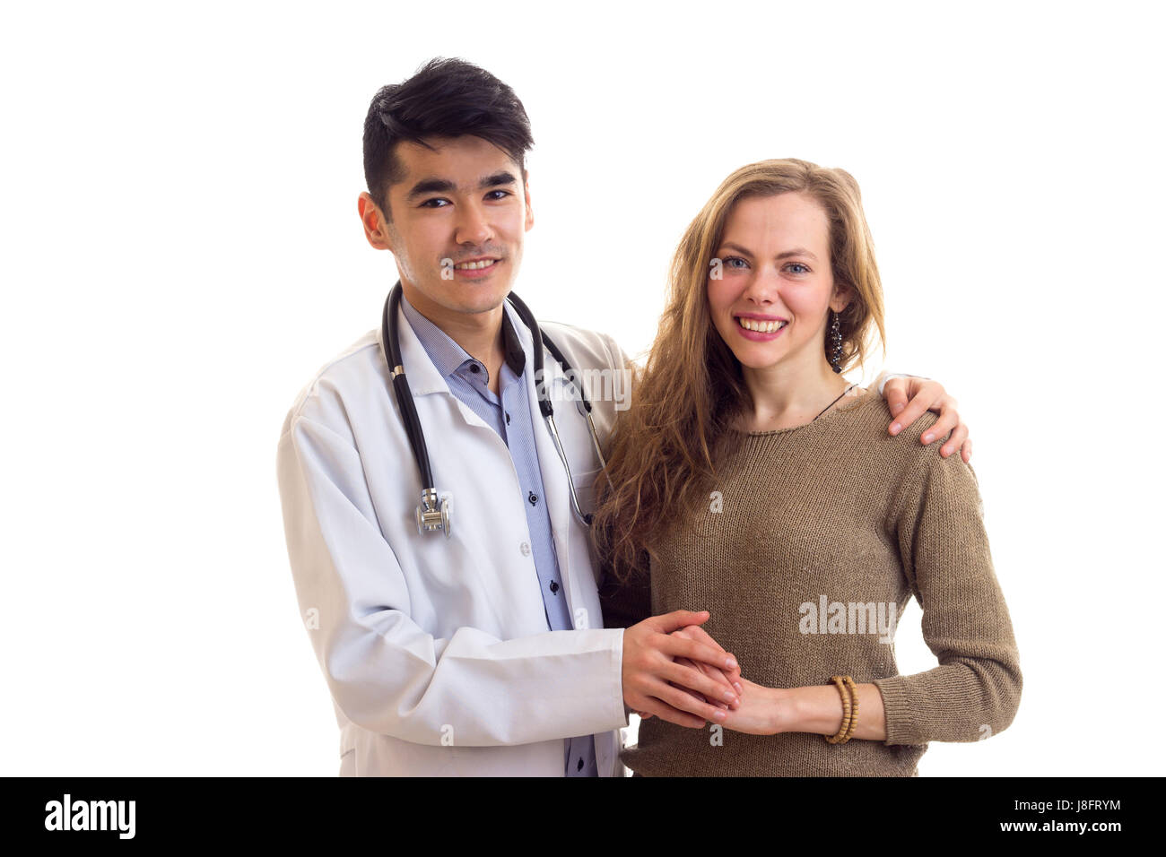 Young positive doctor with dark hair in white gown with stethoscope on ...