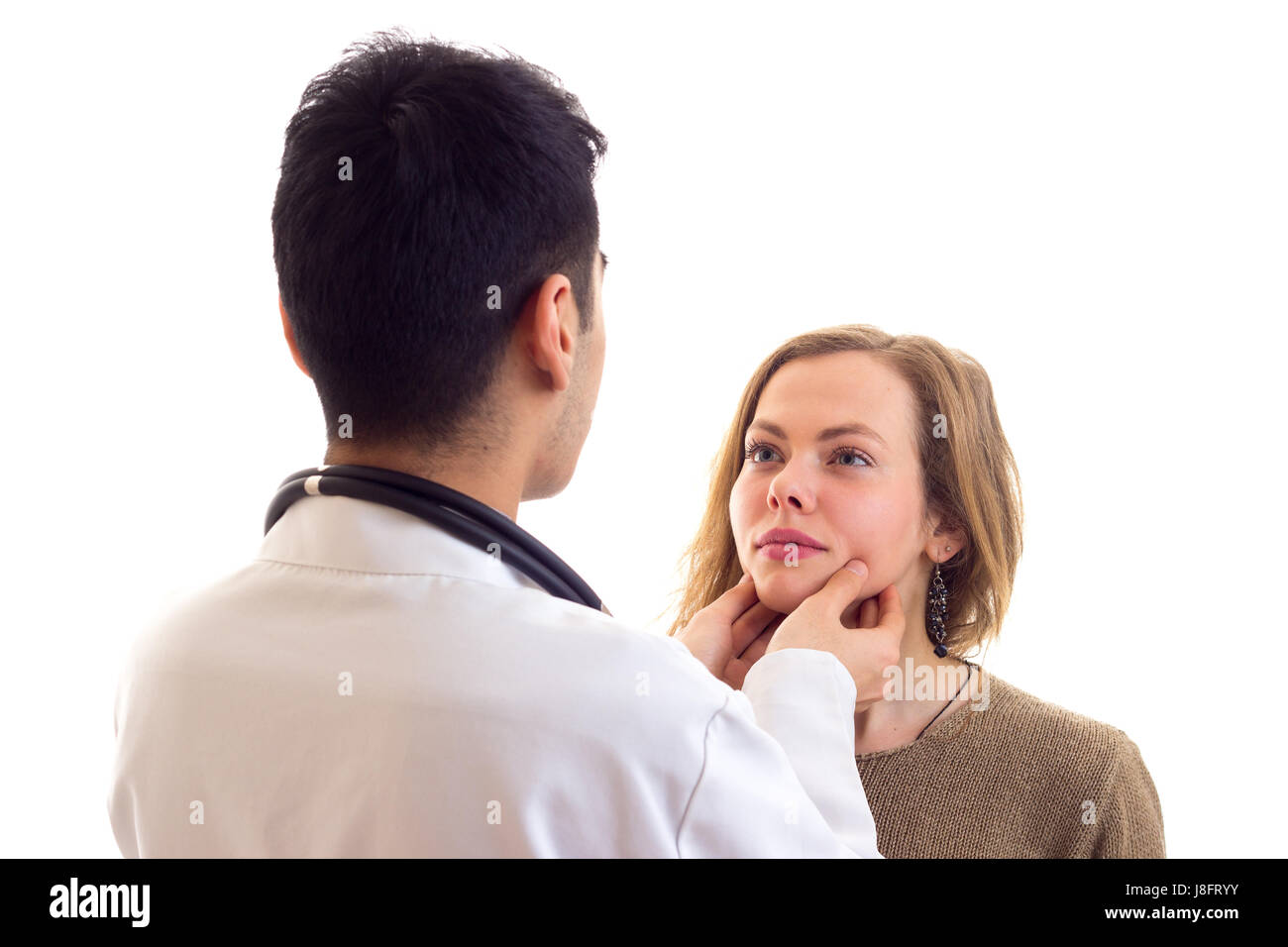 Young doctor with dark hair in white gown with stethoscope on his neck ...