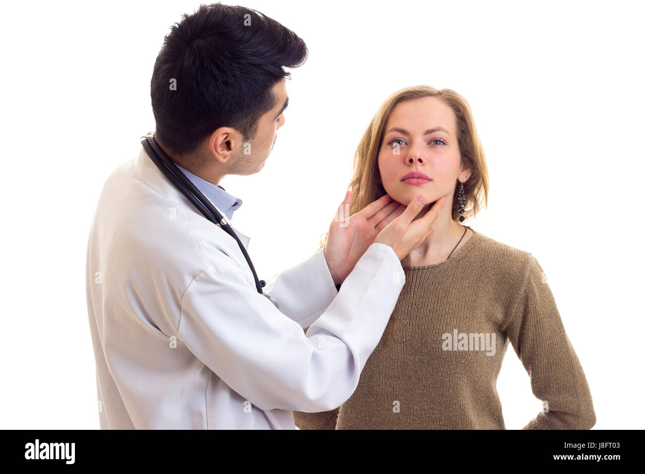 Young doctor with dark hair in white gown with stethoscope on his neck ...