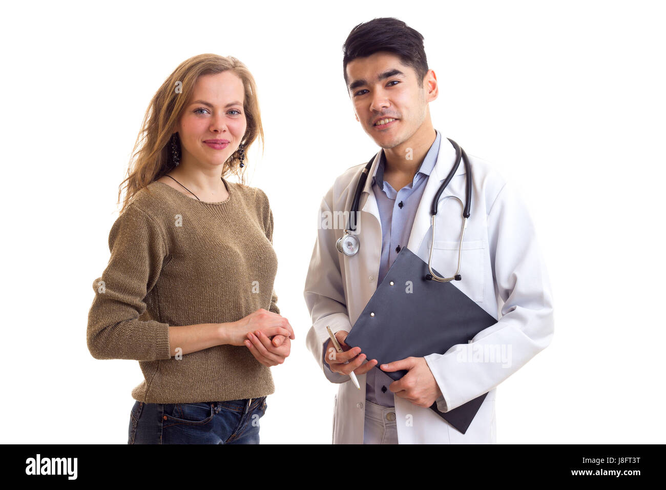Young handsome doctor with black hair in white gown with stethoscope ...
