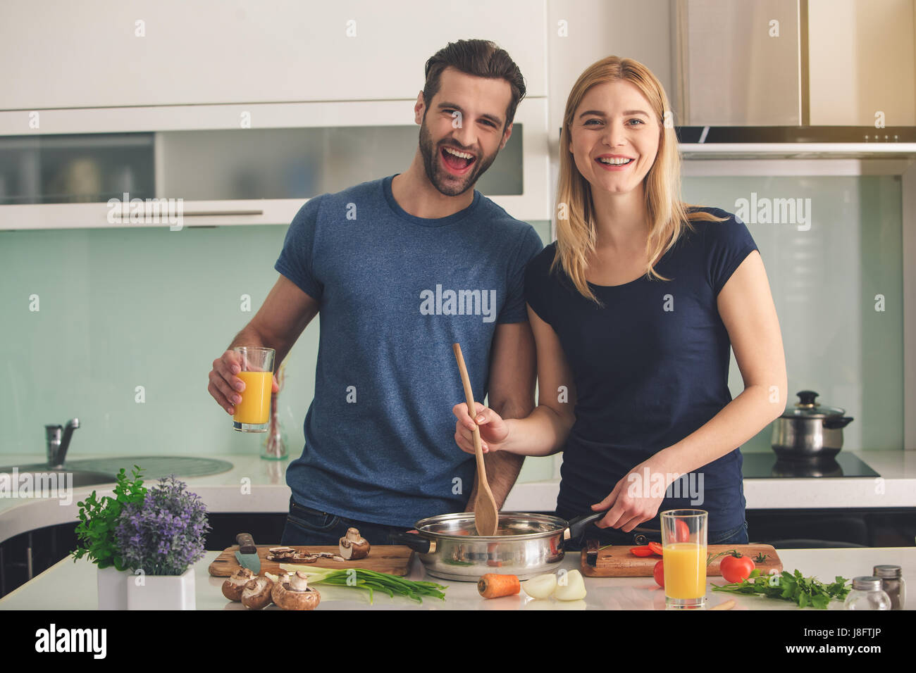 Young couple cooking together meal preparation indoor Stock Photo - Alamy