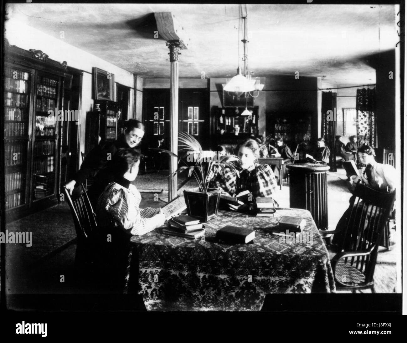 The library and reading room of Oxford College, photographed around ...